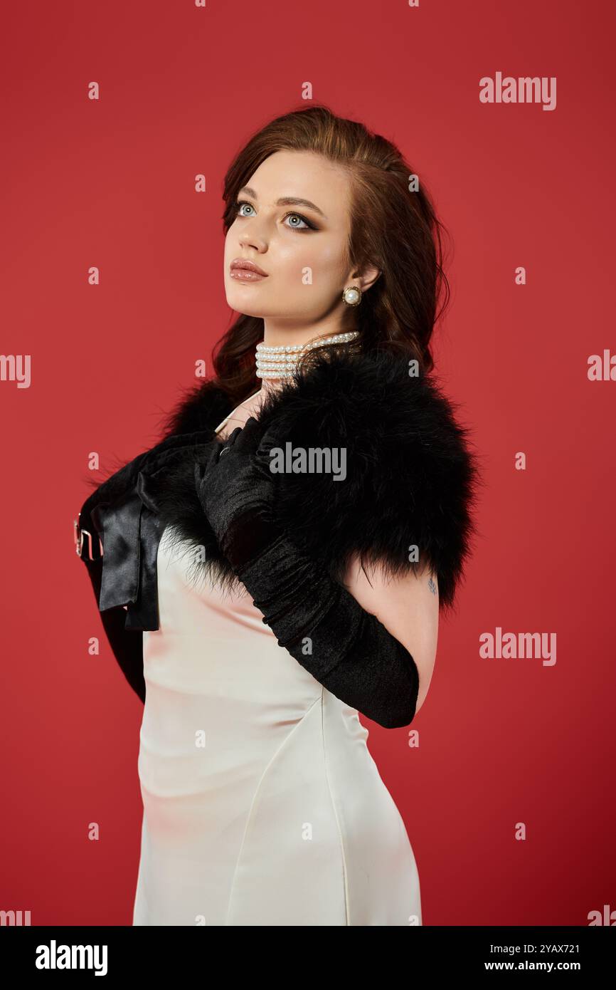 A young beautiful woman showcases her elegance with sophisticated ...