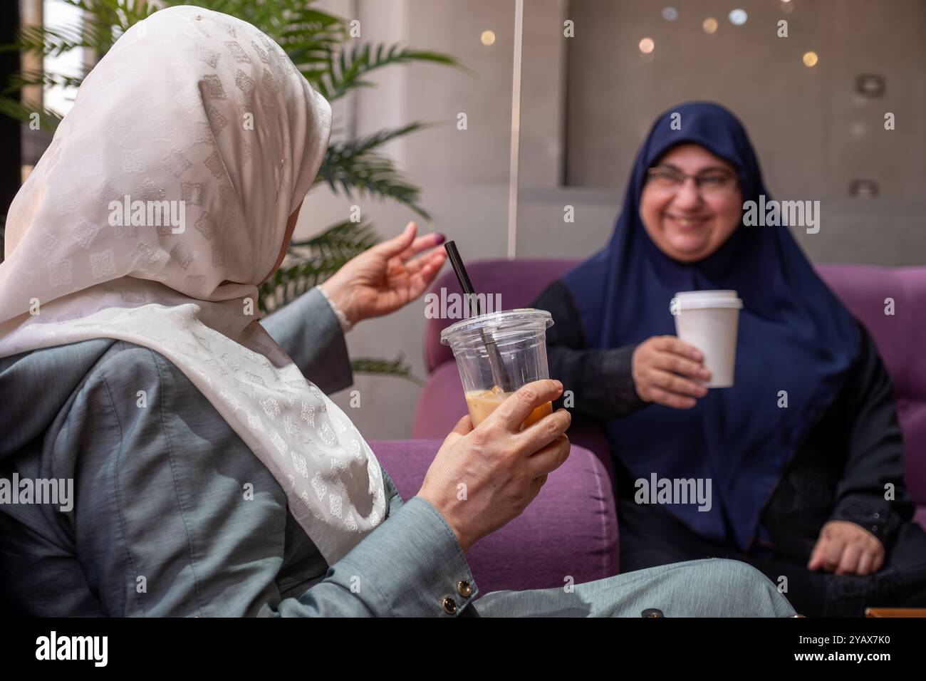 Multi generation group of arabic muslim females talking and having ...