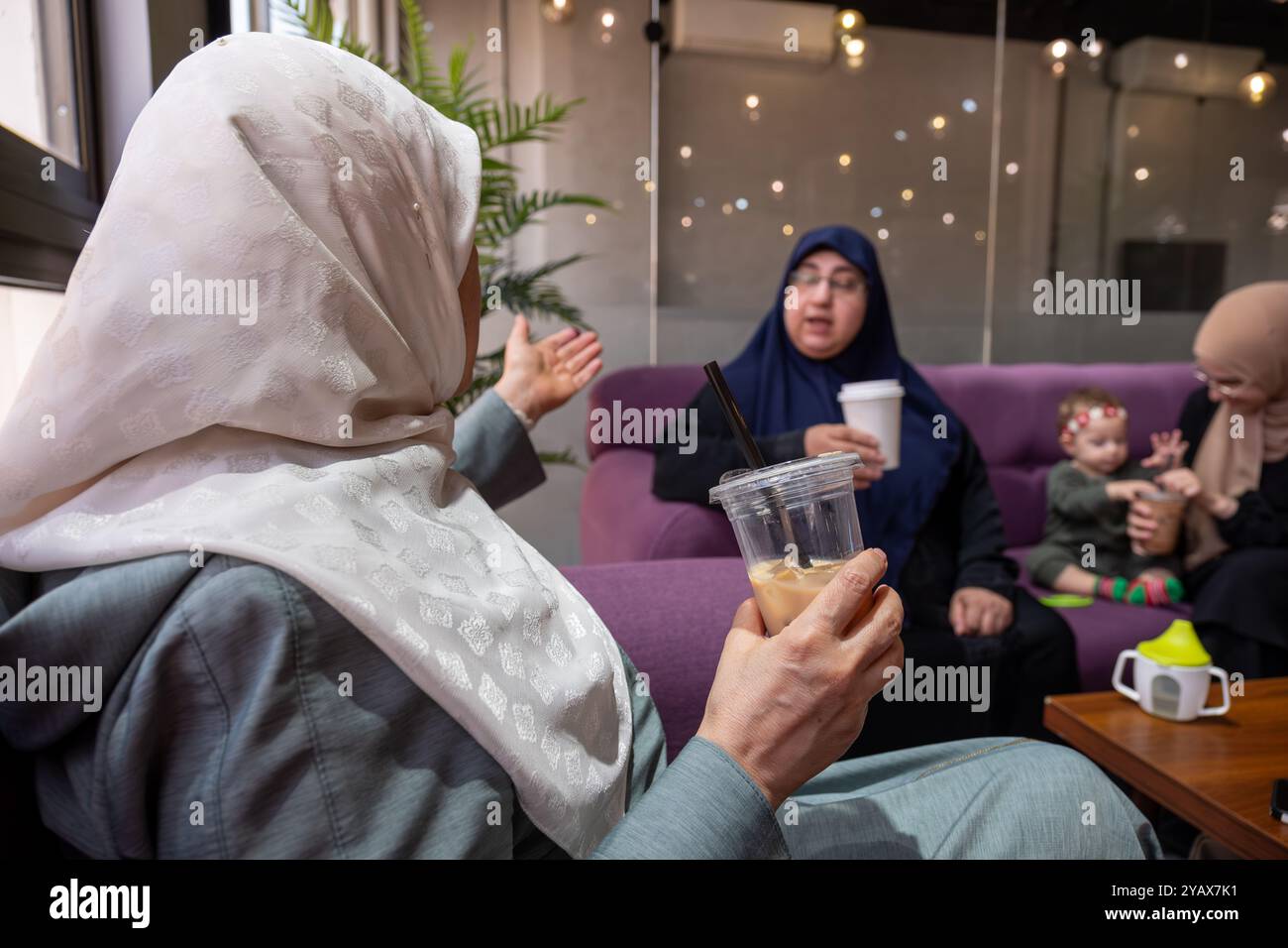 Multi generation group of arabic muslim females talking and having ...