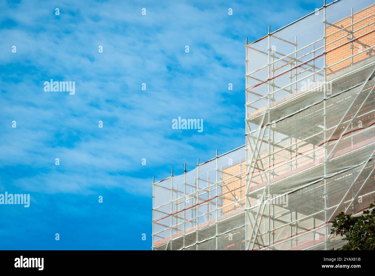 Scaffold sheeting net wrapped apartments building during insulation in ...