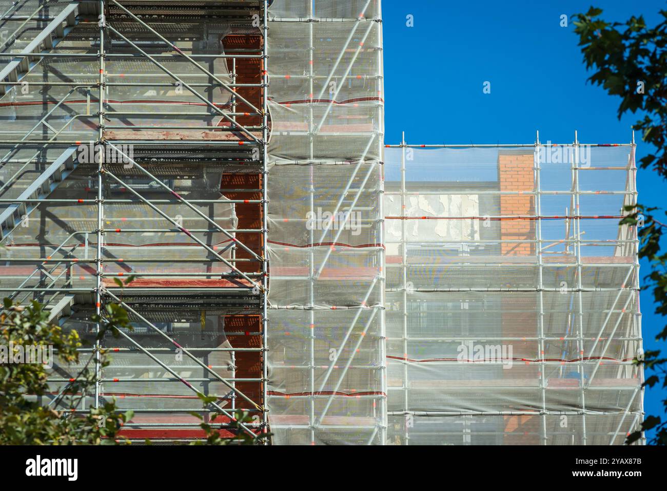 Scaffold sheeting net wrapped apartments building during insulation in ...