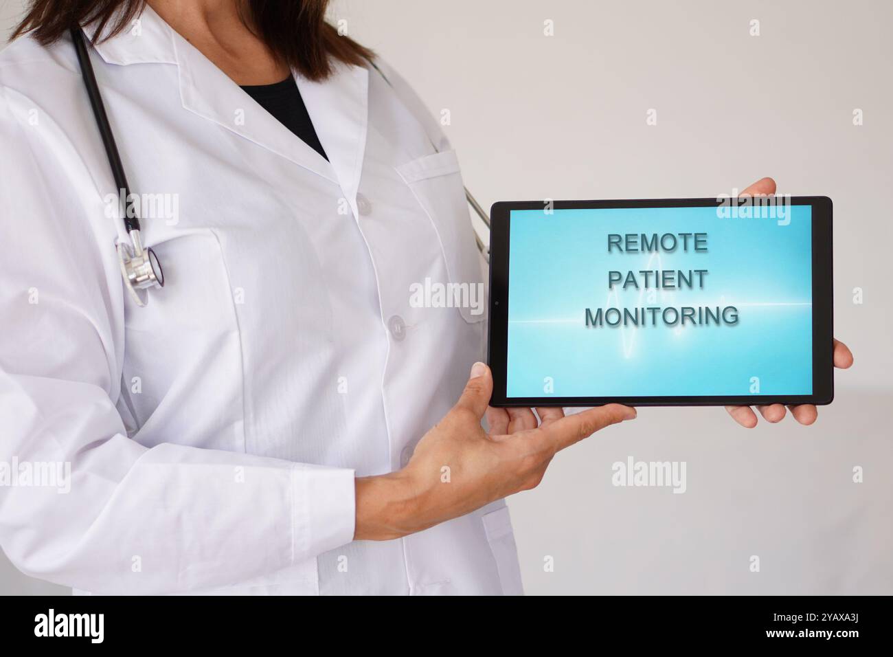 Remote patient monitoring concept. woman doctor showing a tablet with ...