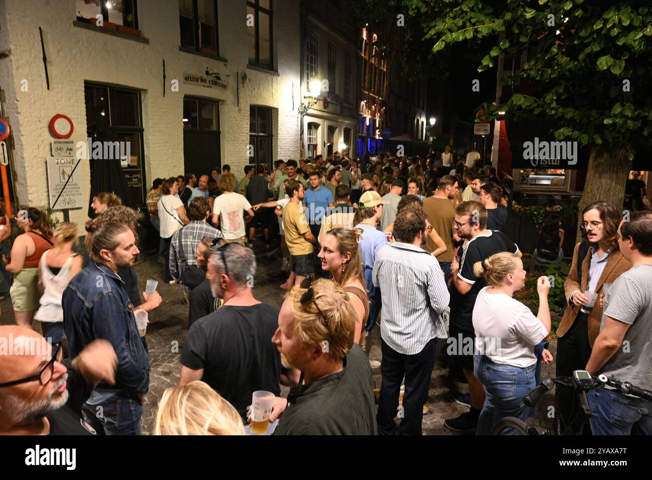 Bruges, Belgium - August 28, 2024: A crowd of people near the bar in ...
