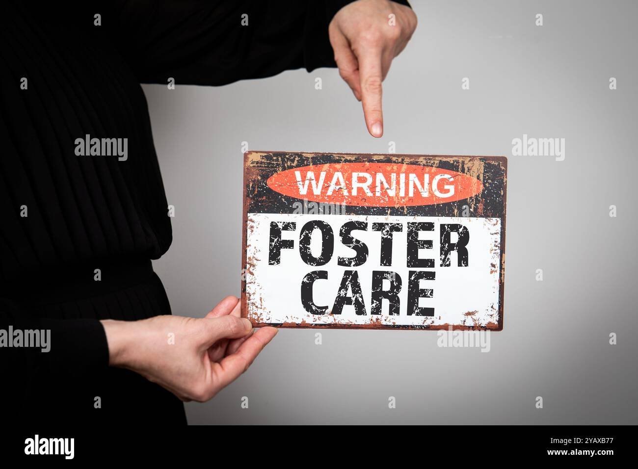 Foster Care. Warning sign with text in the hands of a woman Stock Photo ...
