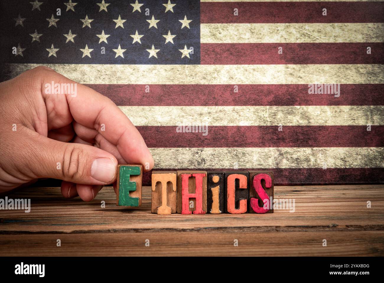 ETHICS. Colorful letters of the alphabet on a wooden texture table ...