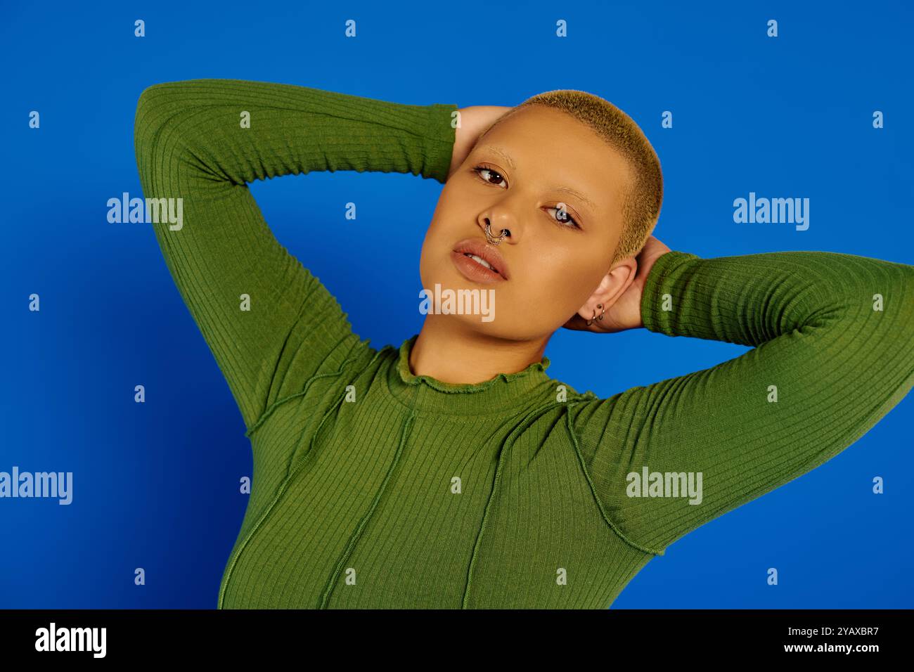 A stylish young woman radiates confidence, flaunting her unique look ...