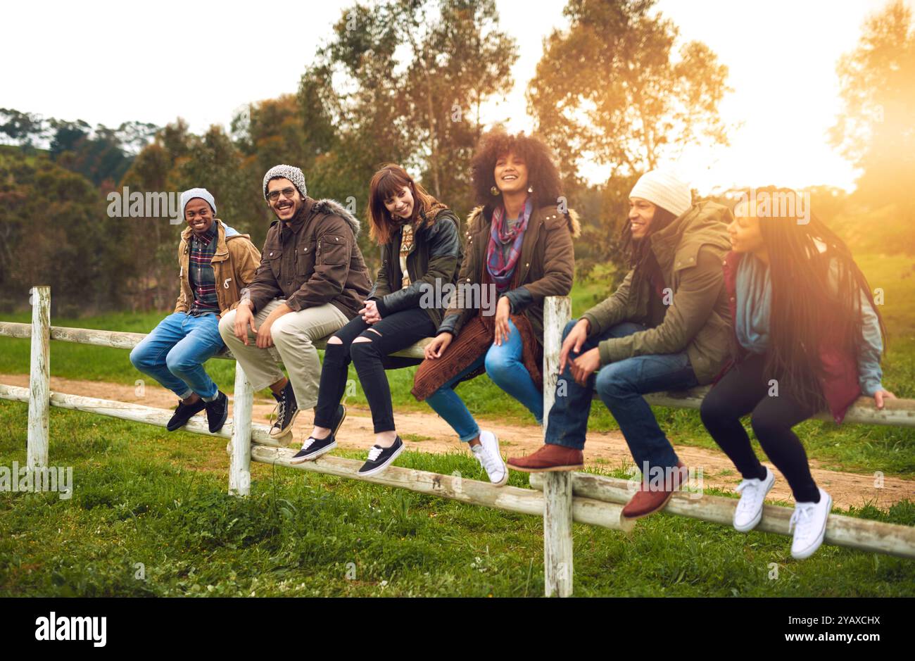 Fence, outdoor and friends in field for travel, holiday and getaway ...