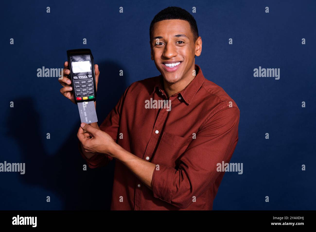 Photo of handsome good mood guy wear casual shirt paying credit card ...