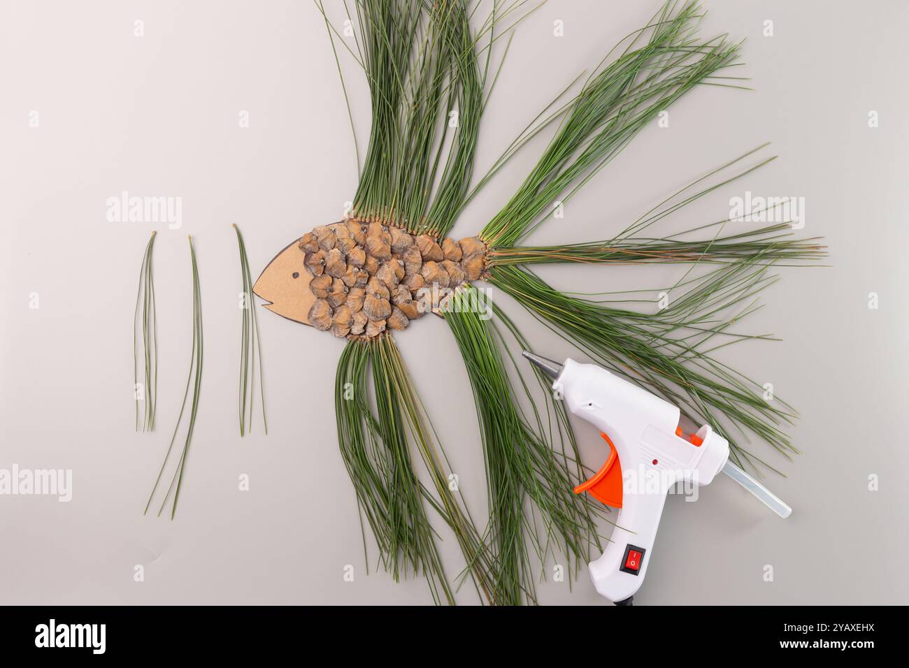 paper fish craft with pine cone needles, step in creative DIY process ...