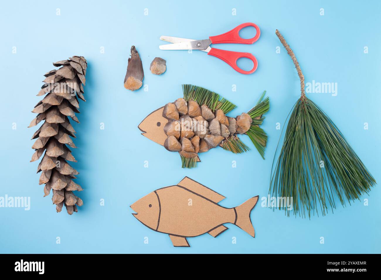 DIY fish craft using pinecone scales, pine needles, and cardboard with ...