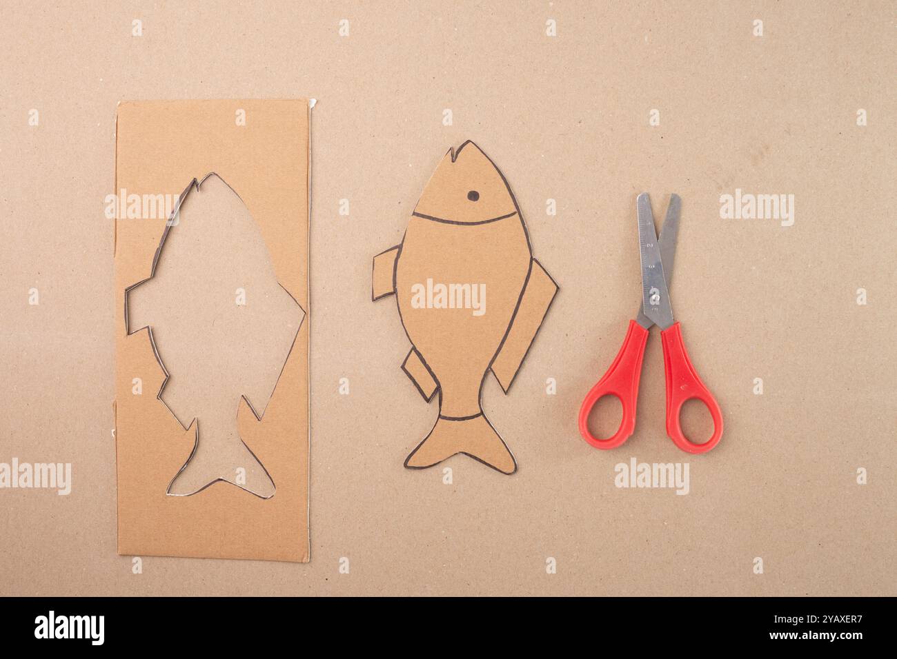 a piece of cardboard with a fish shape cut out of it, step in creative ...