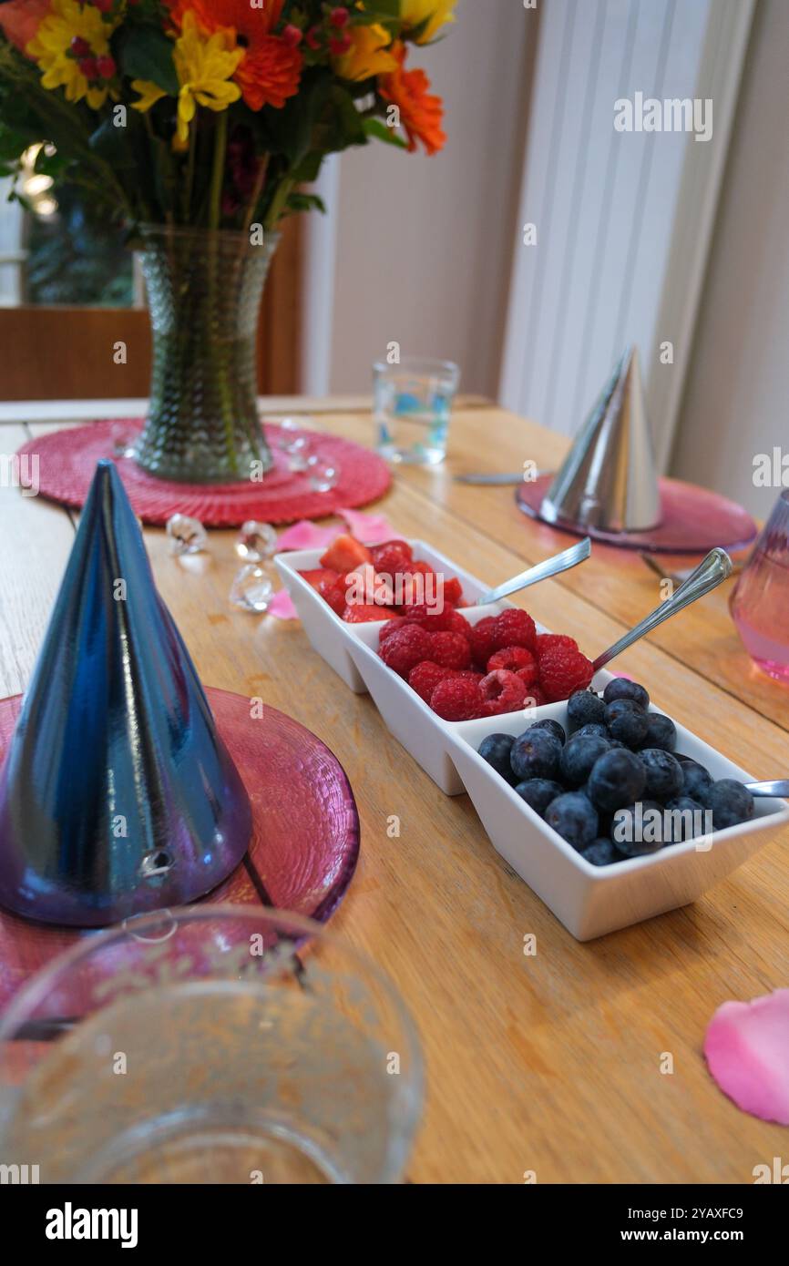 A birthday party celebration table layout with hats and fruit Stock ...