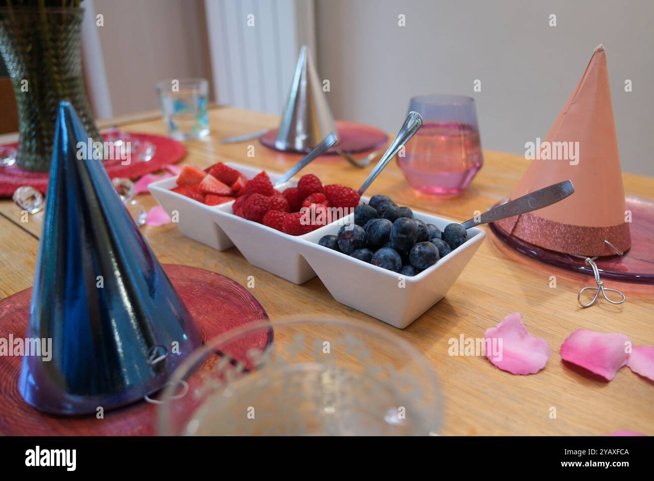 A birthday party celebration table layout with hats and fruit Stock ...