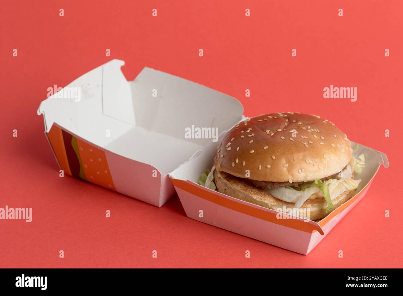 London, United Kingdom, 14th October 2024:- A view of a McDonalds Big Mac, against a red ...