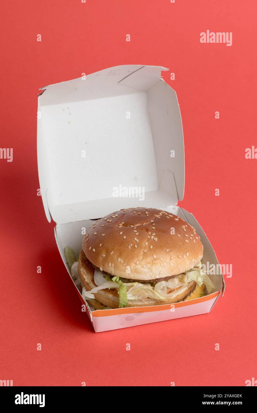 London, United Kingdom, 14th October 2024:- A view of a McDonalds Big Mac, against a red ...