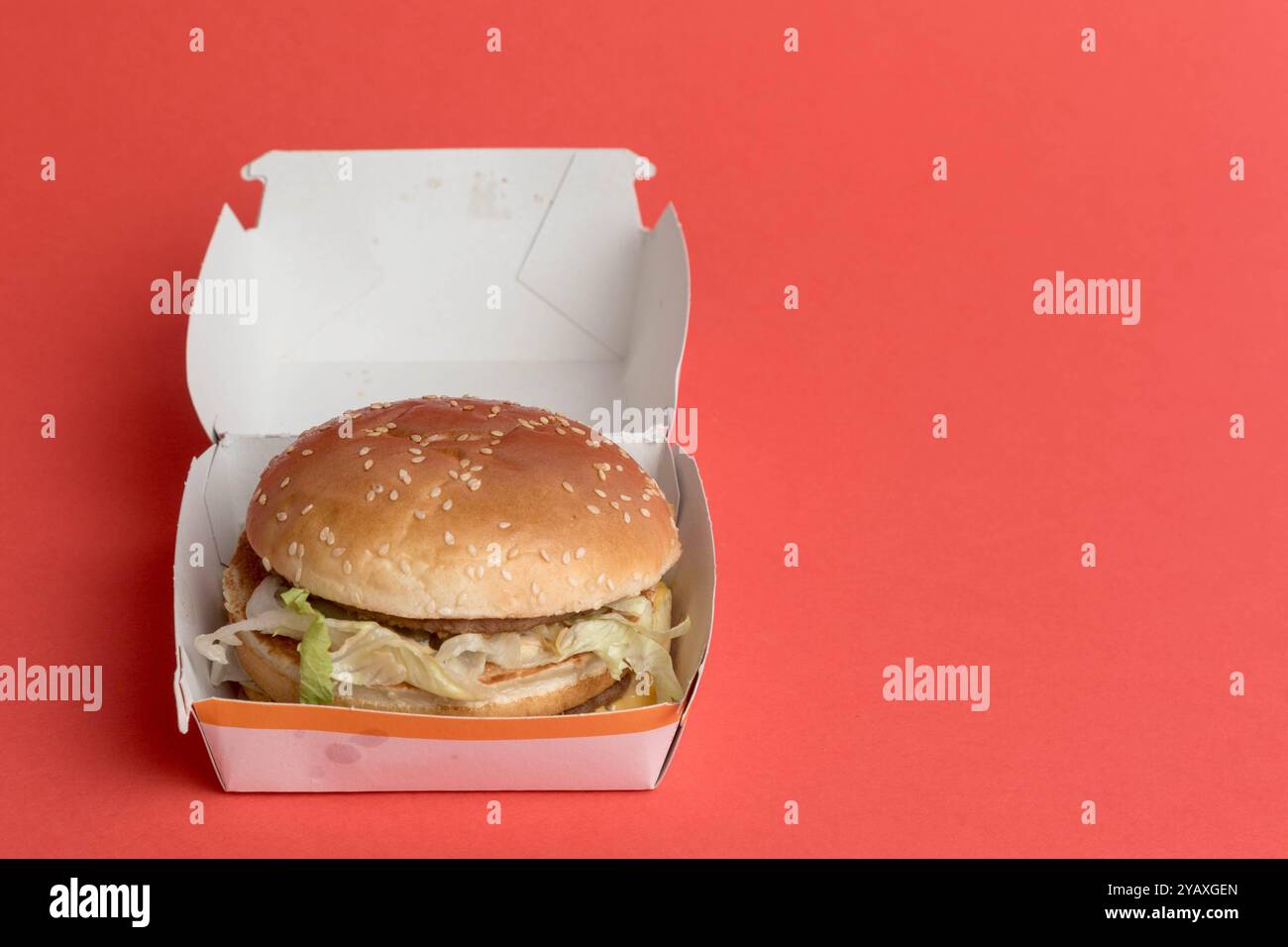 London, United Kingdom, 14th October 2024:- A view of a McDonalds Big Mac, against a red ...