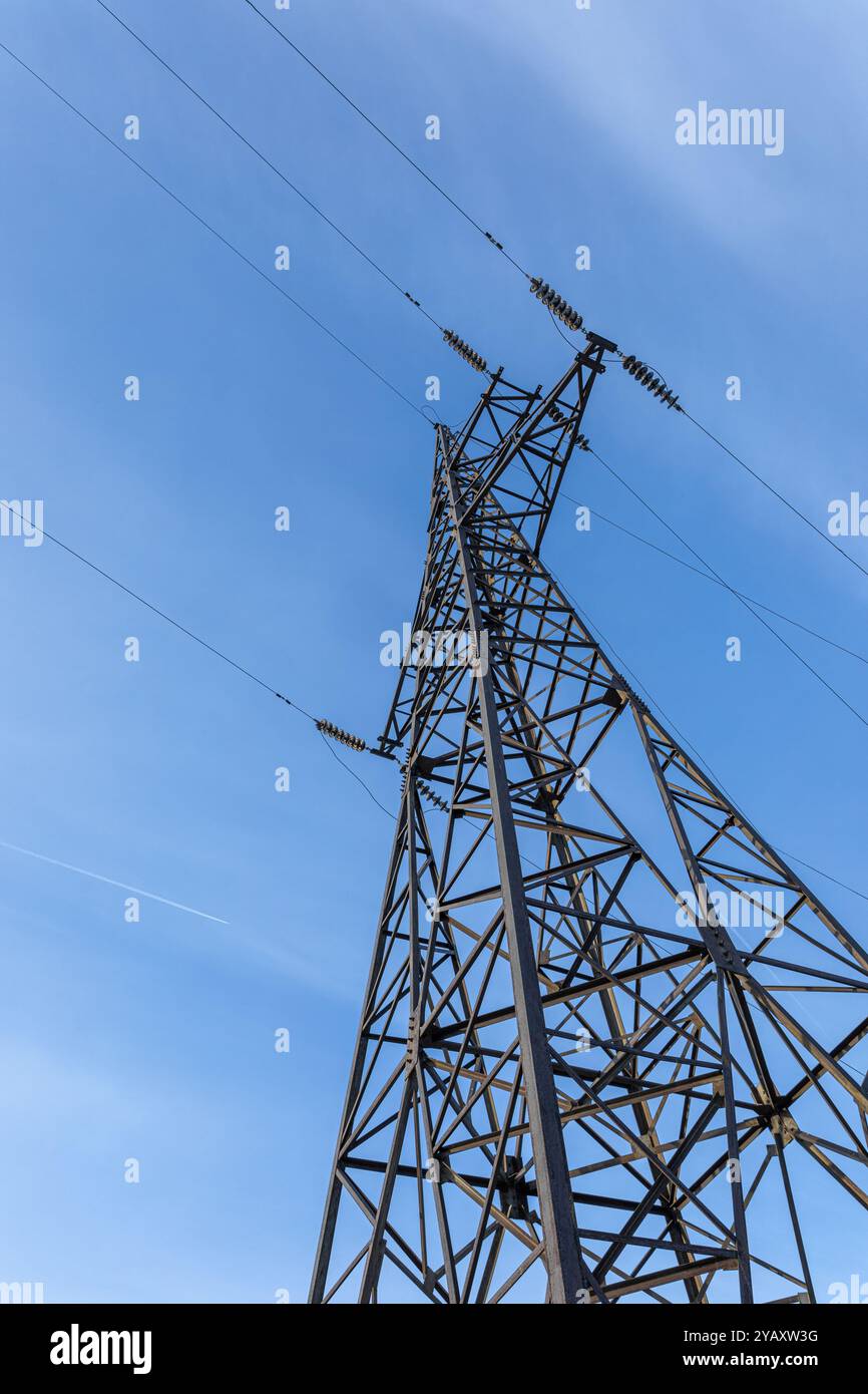 High voltage transmission tower stands tall against expansive clear ...