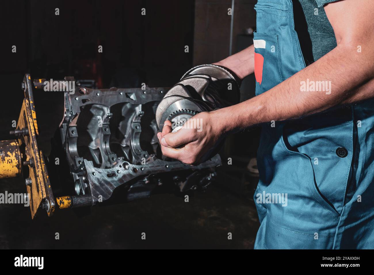 Auto mechanic and car engine part close-up. Side view Stock Photo - Alamy