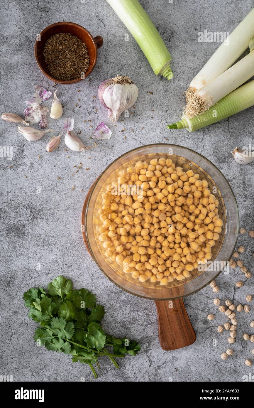 A selection of fresh ingredients, including chickpeas, herbs, and ...