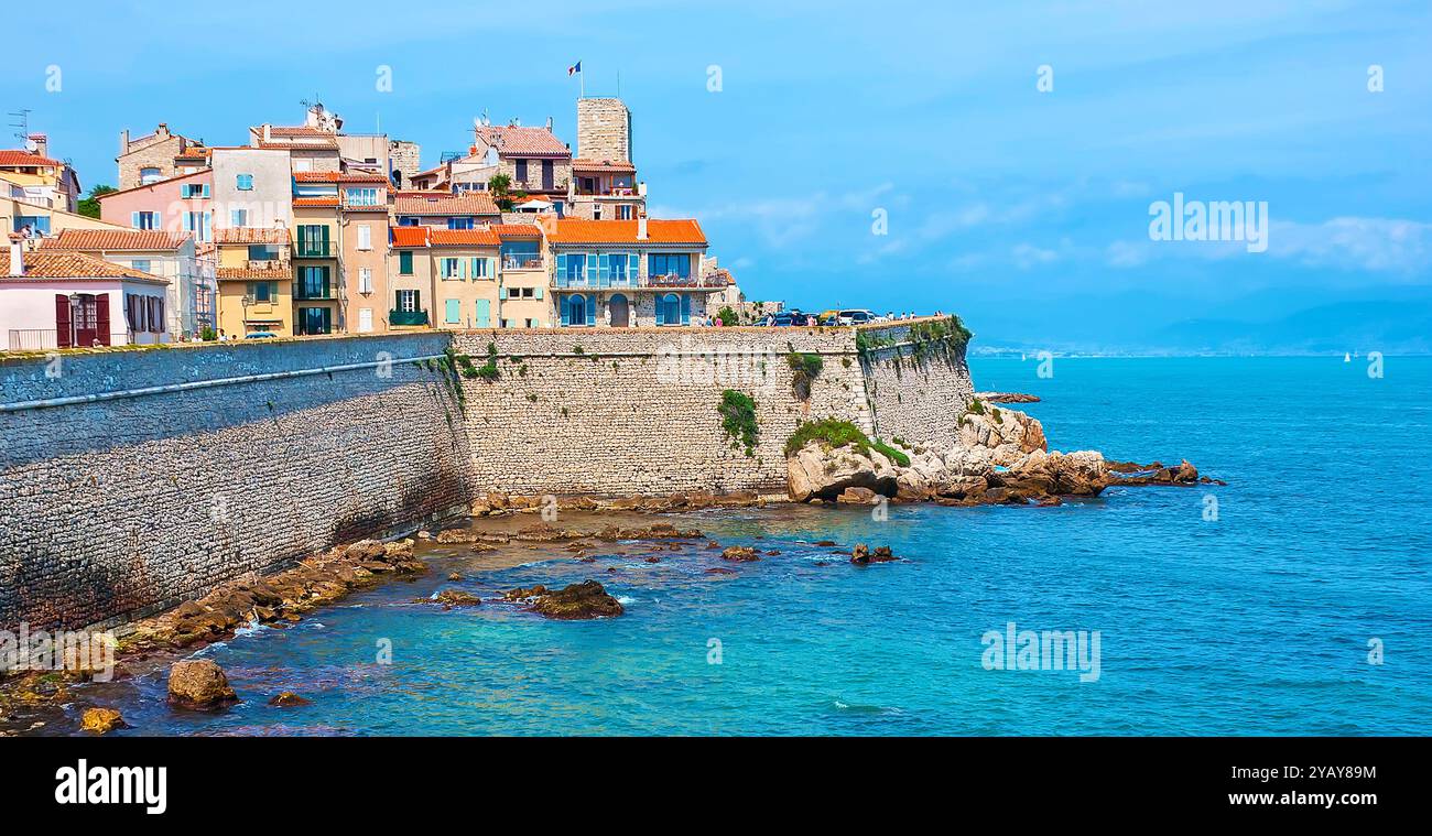 The seaside panorama of Antibes old town with medieval stone city wall ...