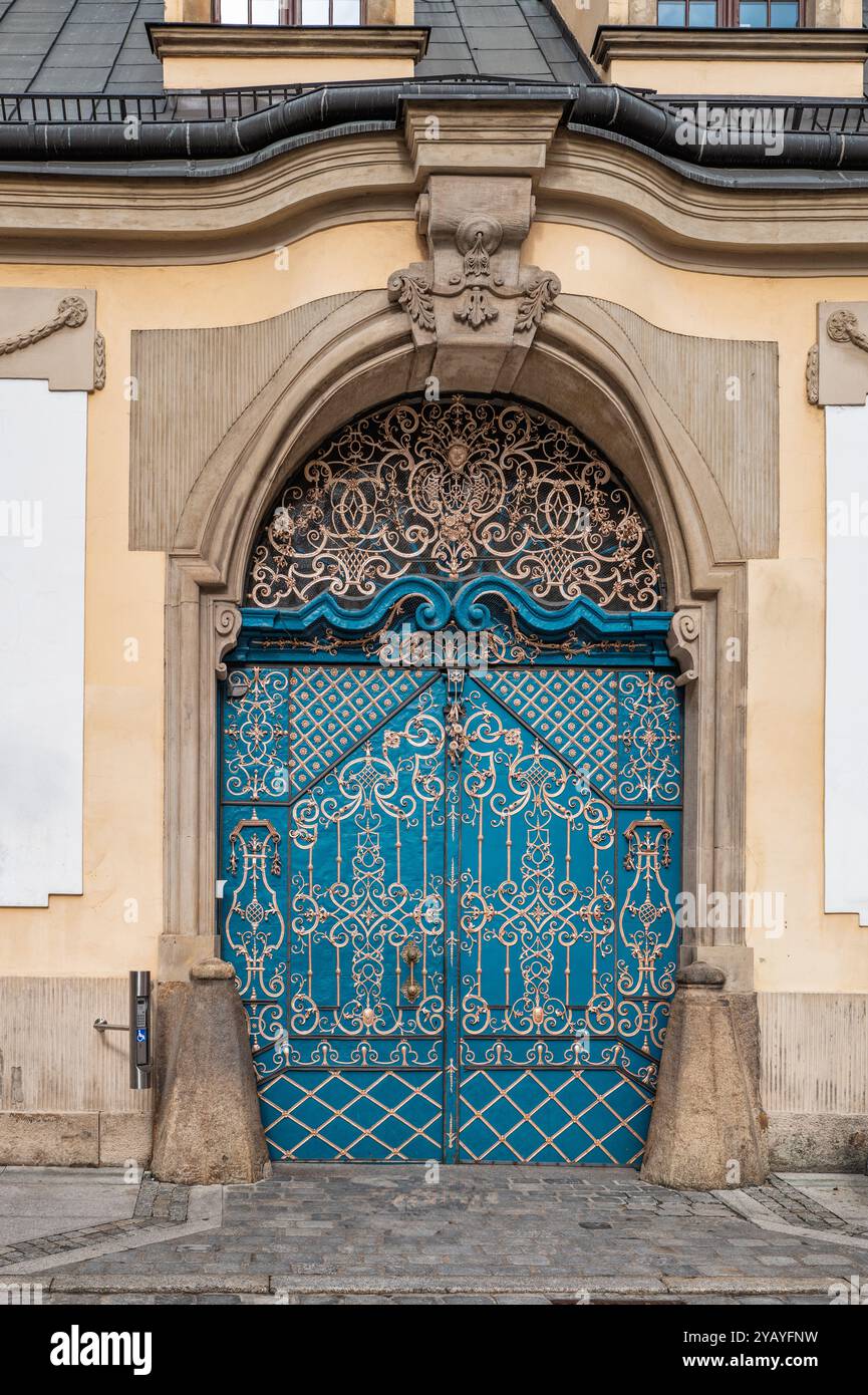 A beautifully ornate blue iron gate accentuates the entrance of a ...