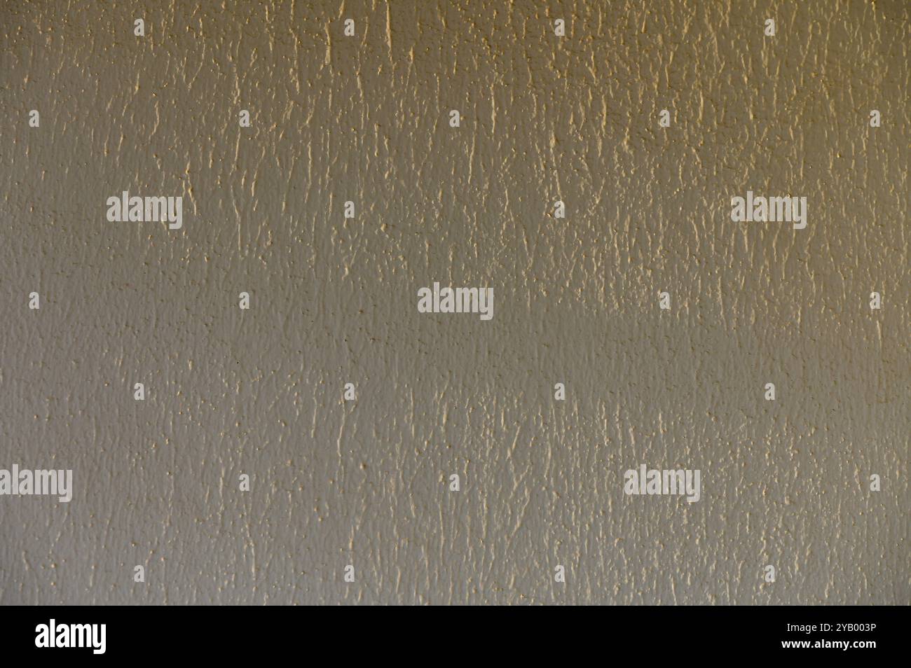 A softly lit interior wall displays an intriguing texture, where gentle ...