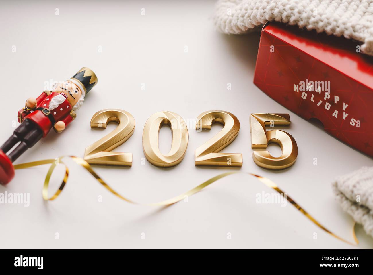 Red gift box with numbers revealing the New Year 2025, surrounded by ...