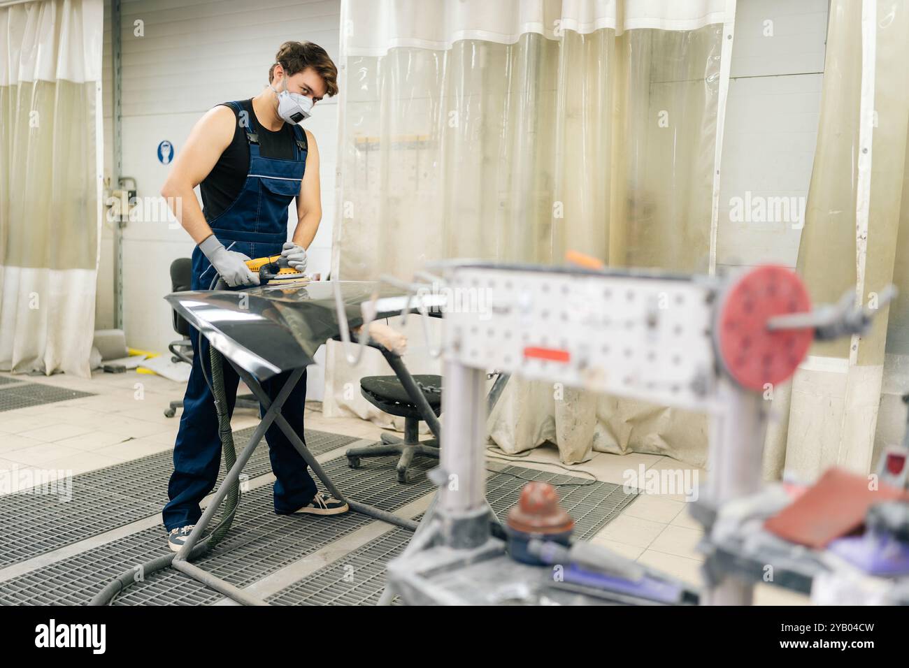 Mechanic male using machinery car polishers maintenance to remove marks ...