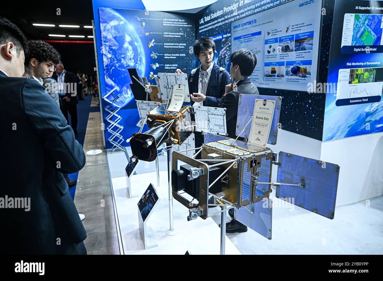 Visitors next to models of satellites on display at the Korea Aerospace ...