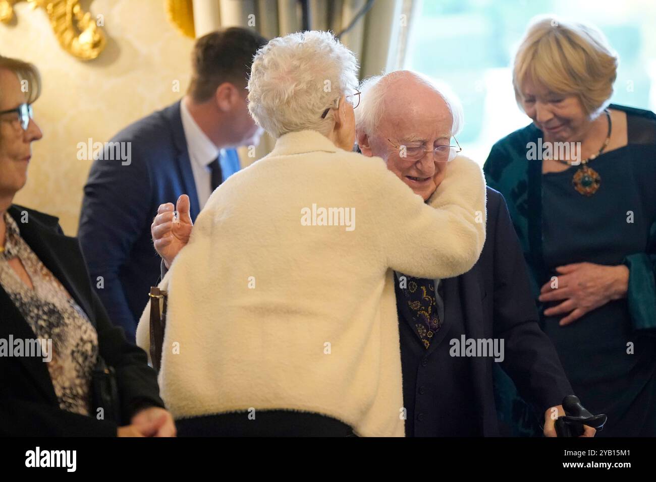 President of Ireland Michael D Higgins hugs Bridget McDermott during a ...