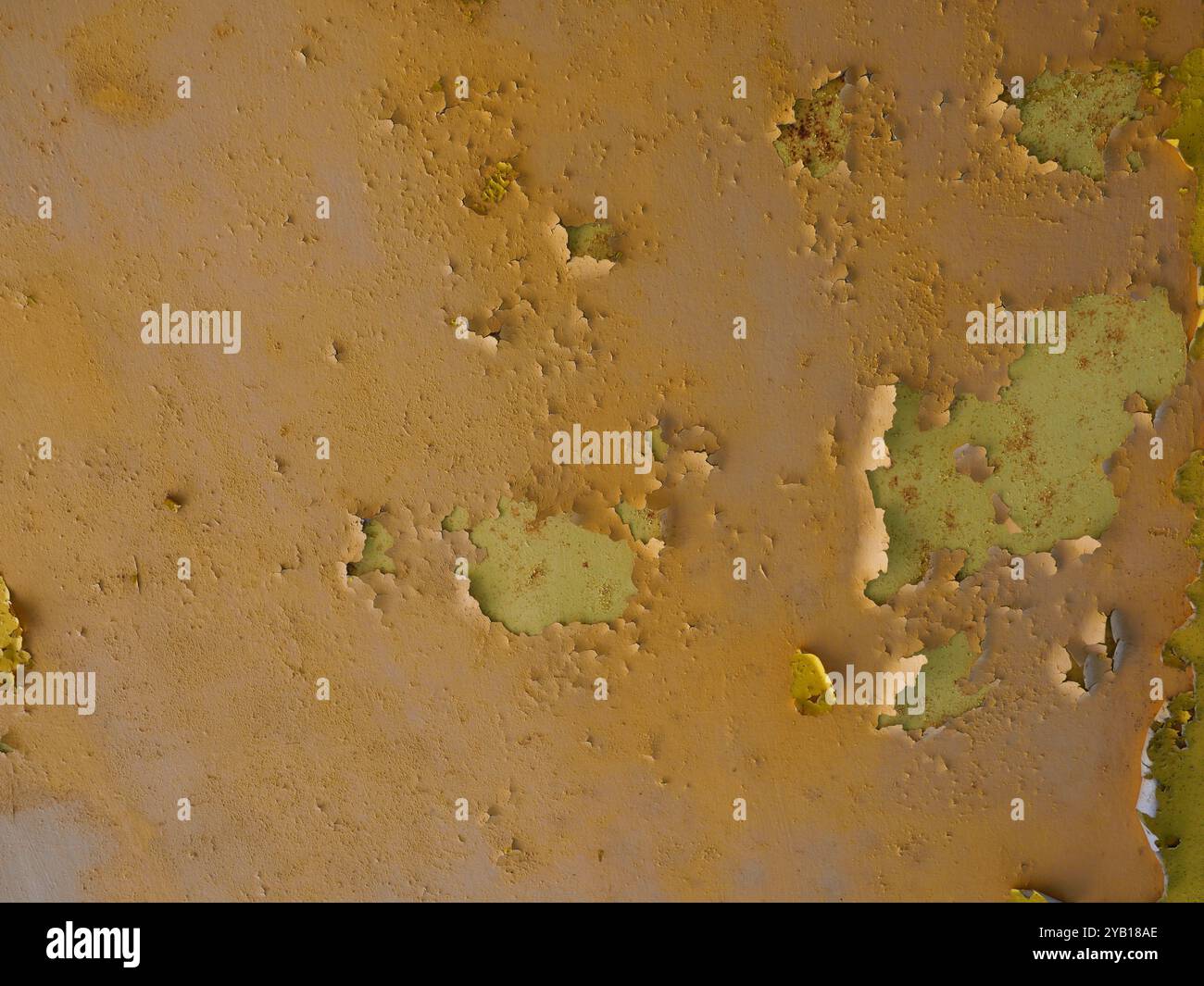 Peeling yellow paint from a steel beam. The rust shows through. A ...