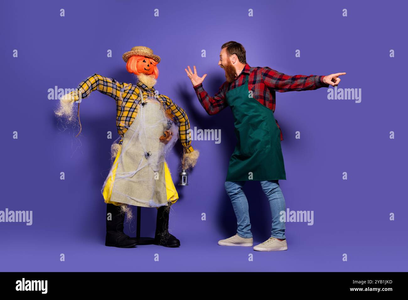 Photo of mad furious man farmer shouting loud scary scarecrow doll ...