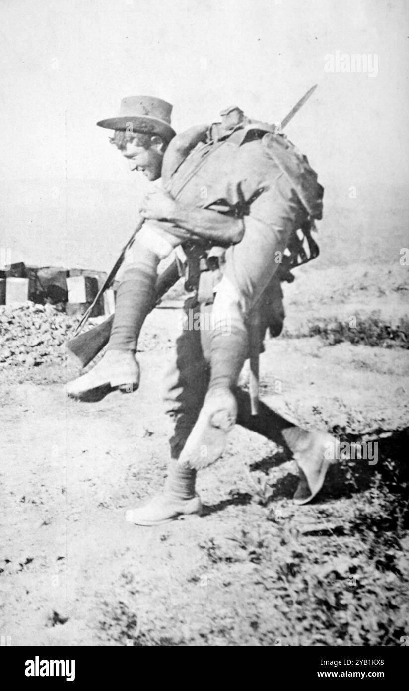An Australian soldier carrying a wounded colleague from the front line ...