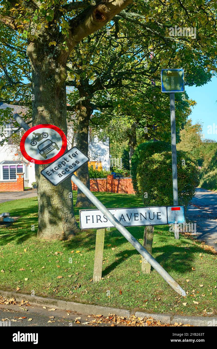 Damaged road sign and traffic sign on a quite rural avenue Stock Photo ...