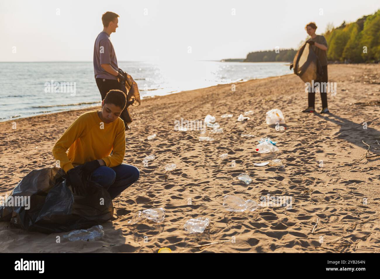 Earth day. Volunteers activists collects garbage cleaning of beach ...