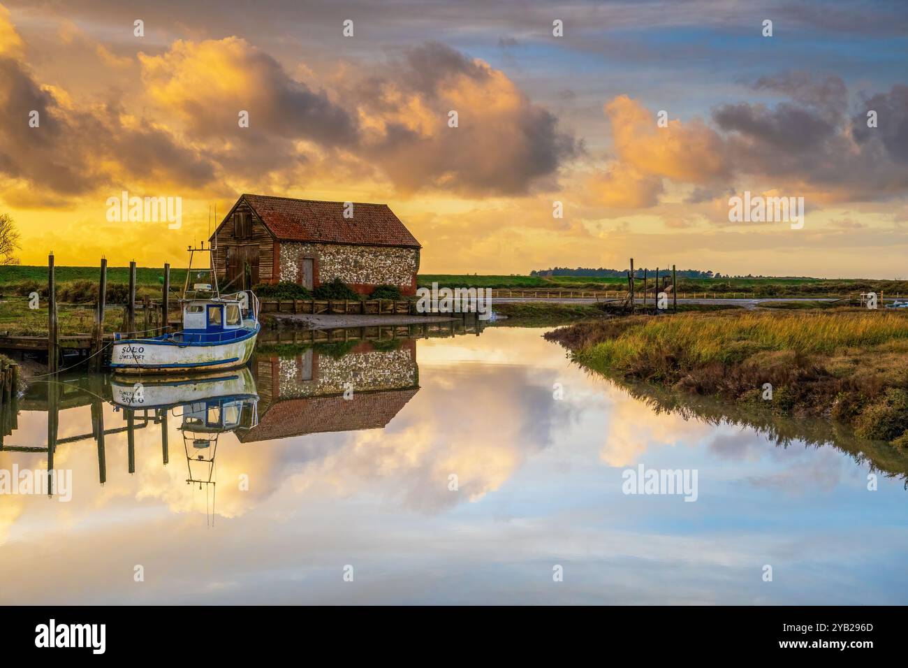 The old Coal Barn and Quay at Thornham Old Harbour, during sunset ...