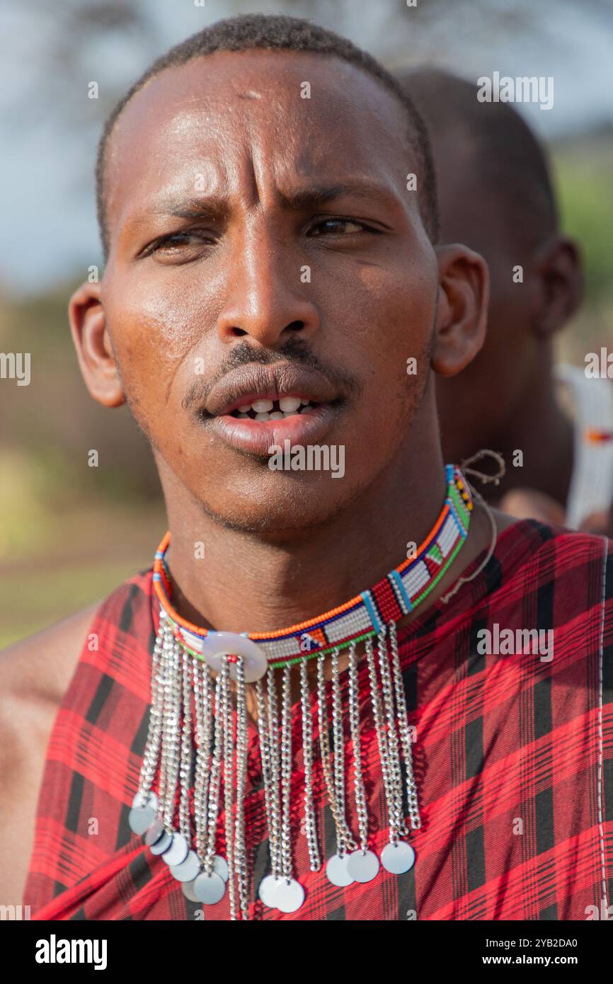 Male member of the Masai tribe, in traditional red clothing. Masai Mara ...