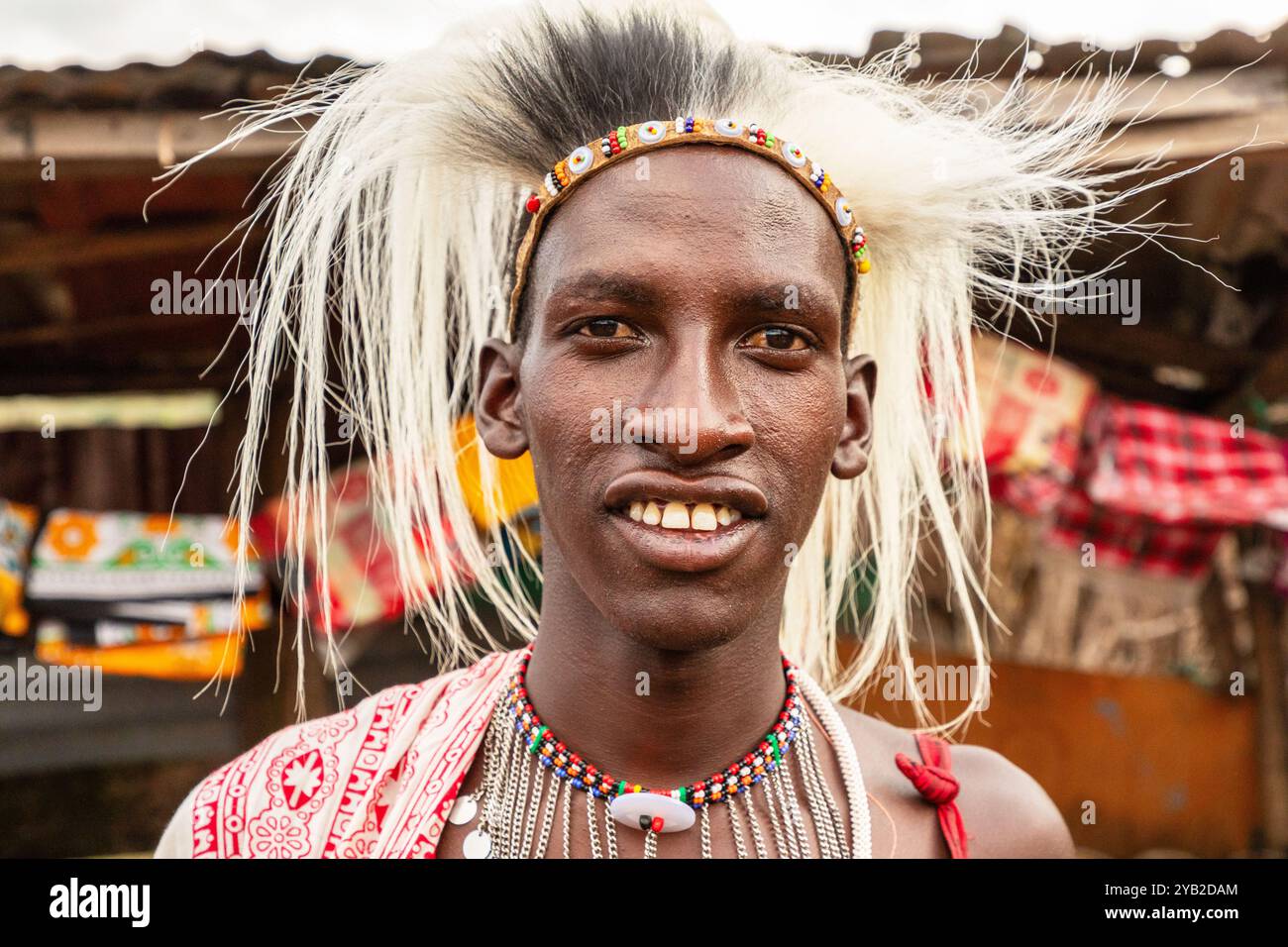 Male member of the Masai tribe, in traditional red clothing. Masai Mara ...
