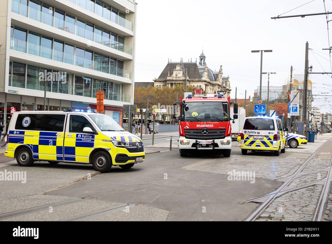 Antwerp, Belgium. 16th Oct, 2024. Police vans and a fire brigade truck ...