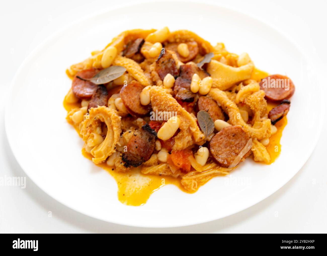 Beef tripe (bucho), beef stomach, tripe on a white plate. Dobradinha ...