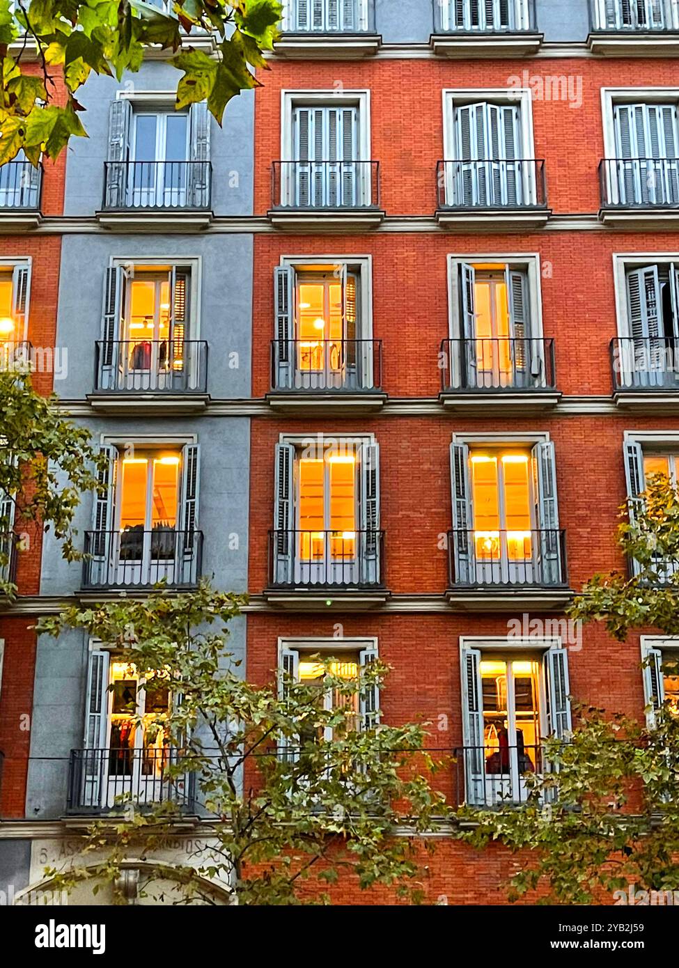 Facade of building with lit up windows. Madrid, Spain Stock Photo - Alamy