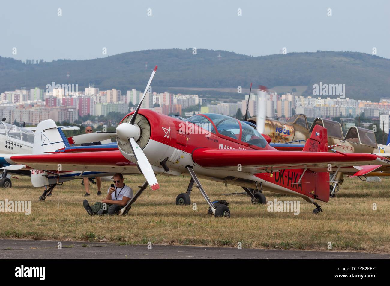 A pilot resting under the wing of a Sukhoi Su-29 aircraft.. Air Show ...