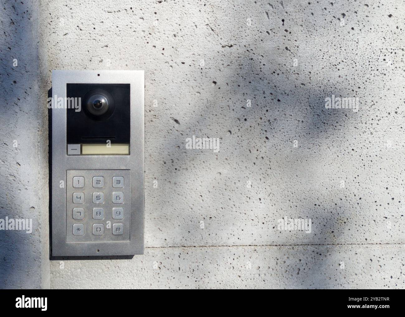 Metal intercom with keypad on concrete wall Stock Photo - Alamy