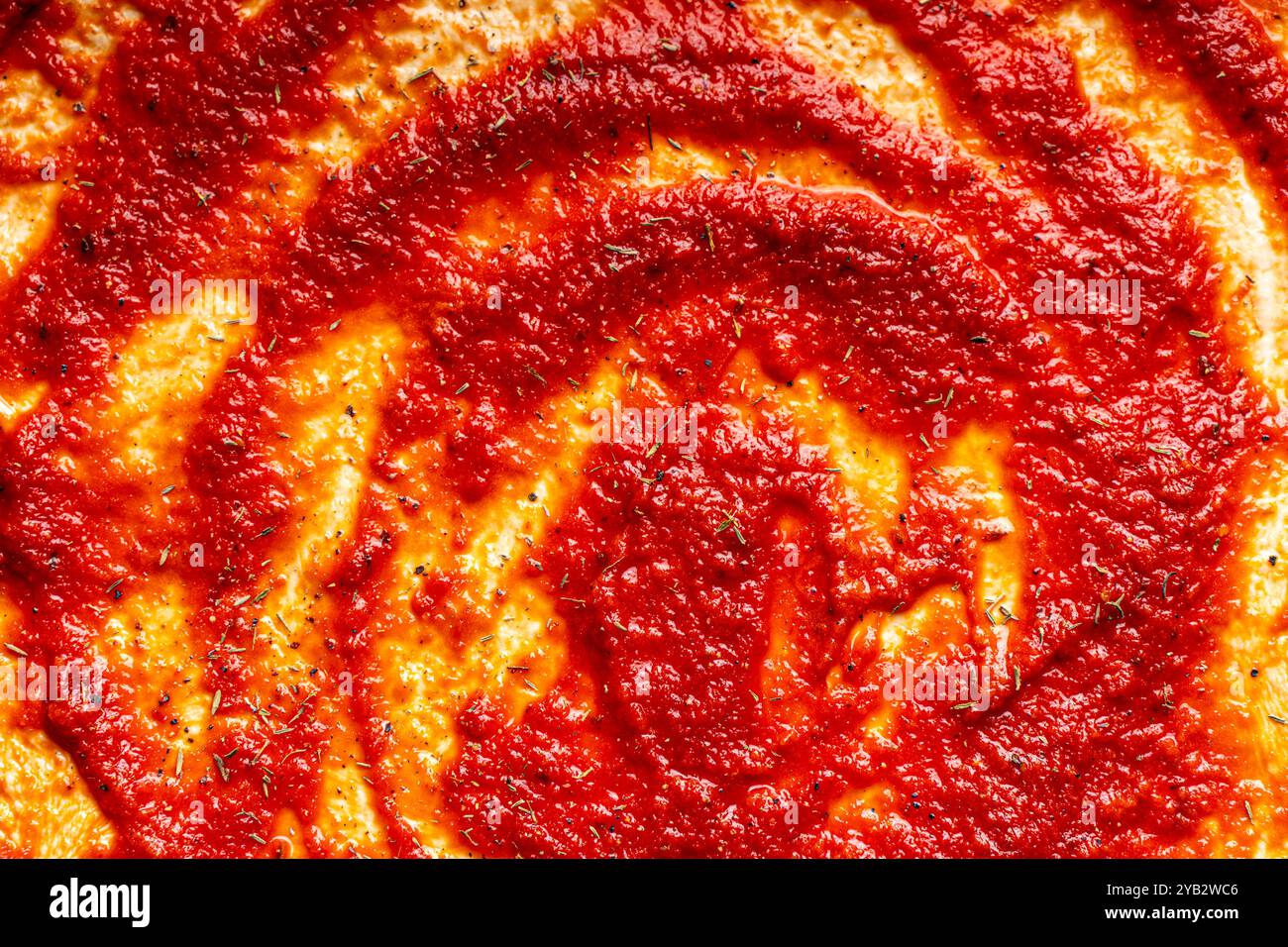Background: Texture of pizza dough covered with tomato sauce. The sauce ...