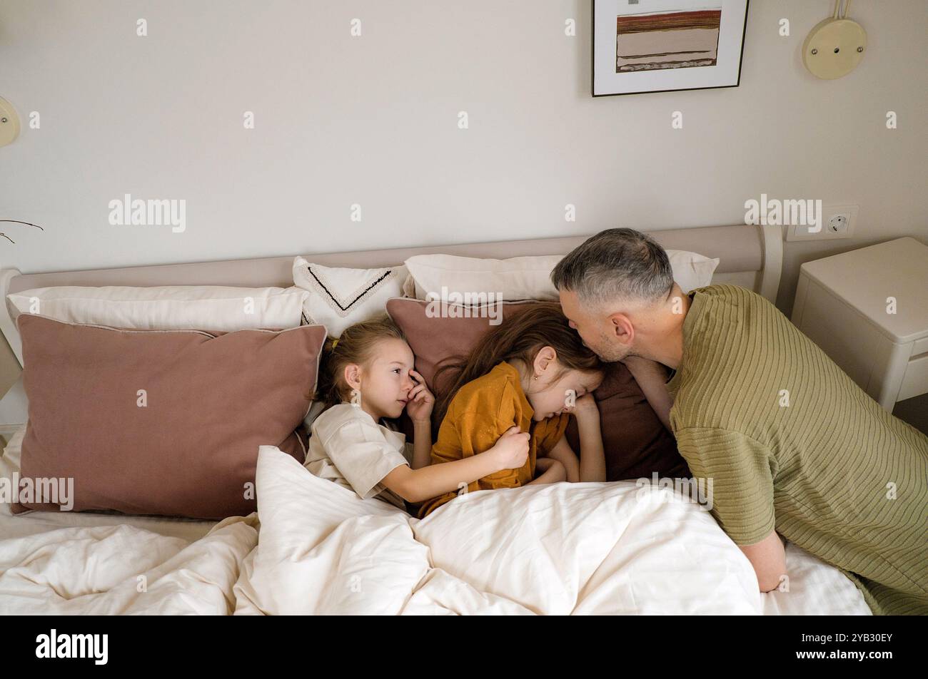 Tucking in kids hi-res stock photography and images - Alamy