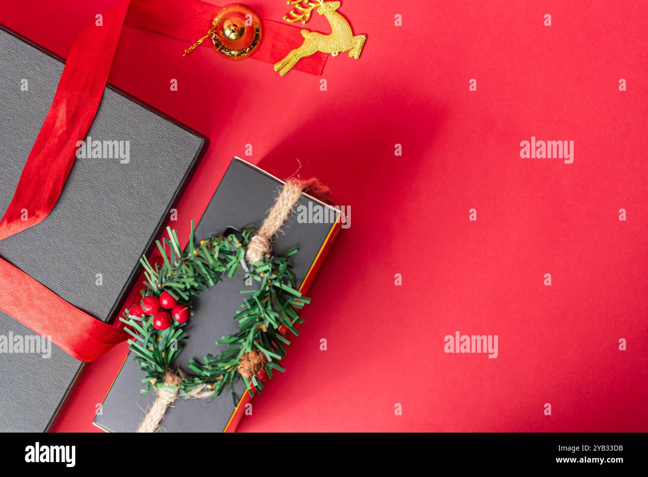 Christmas-themed gift boxes on a red background with decorations Stock ...