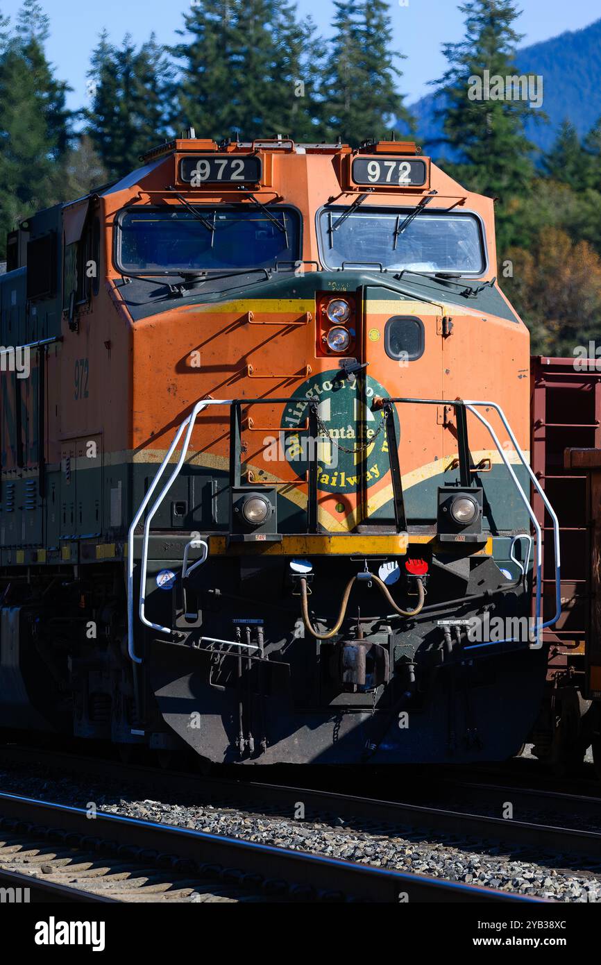Skykomish, WA, USA - October 12, 2024; BNSF orange freight locomotive cab in close up with track ...