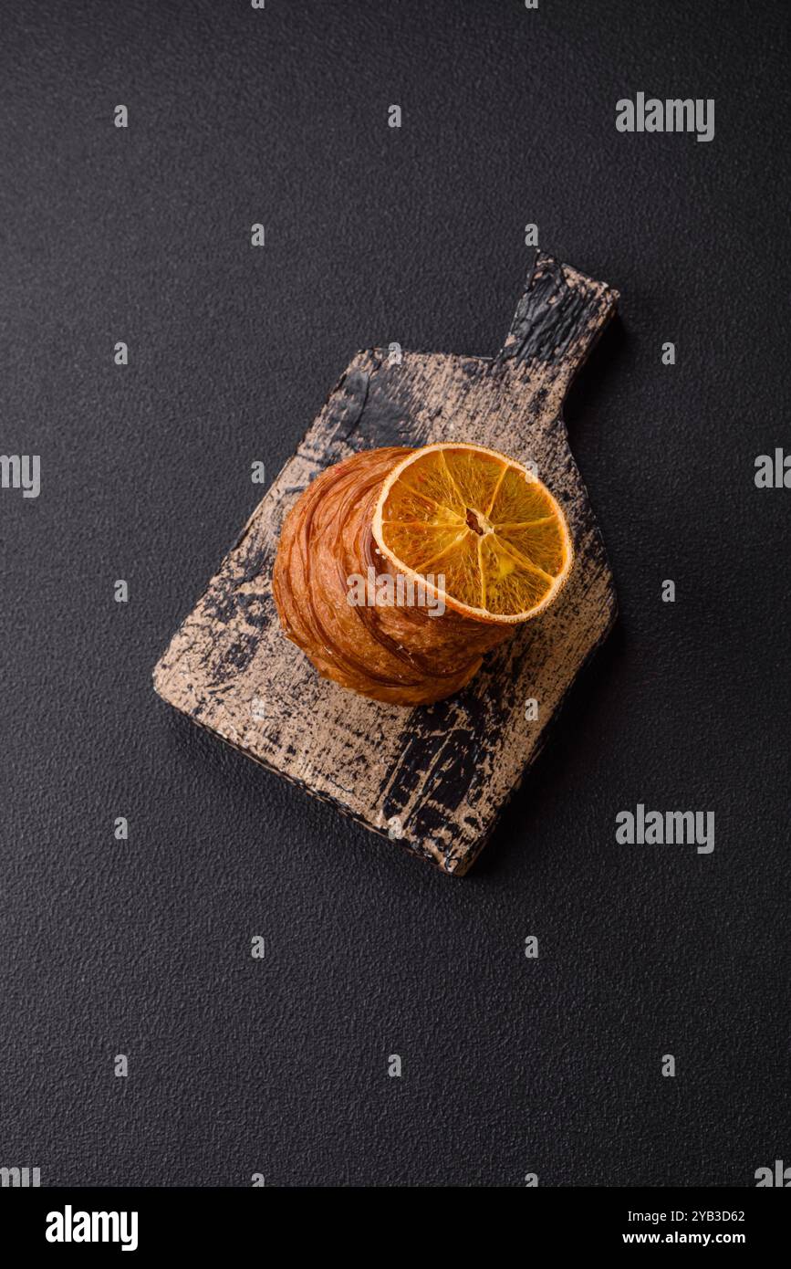 Sweet craffin made from puff pastry with Swiss meringue on a dark ...