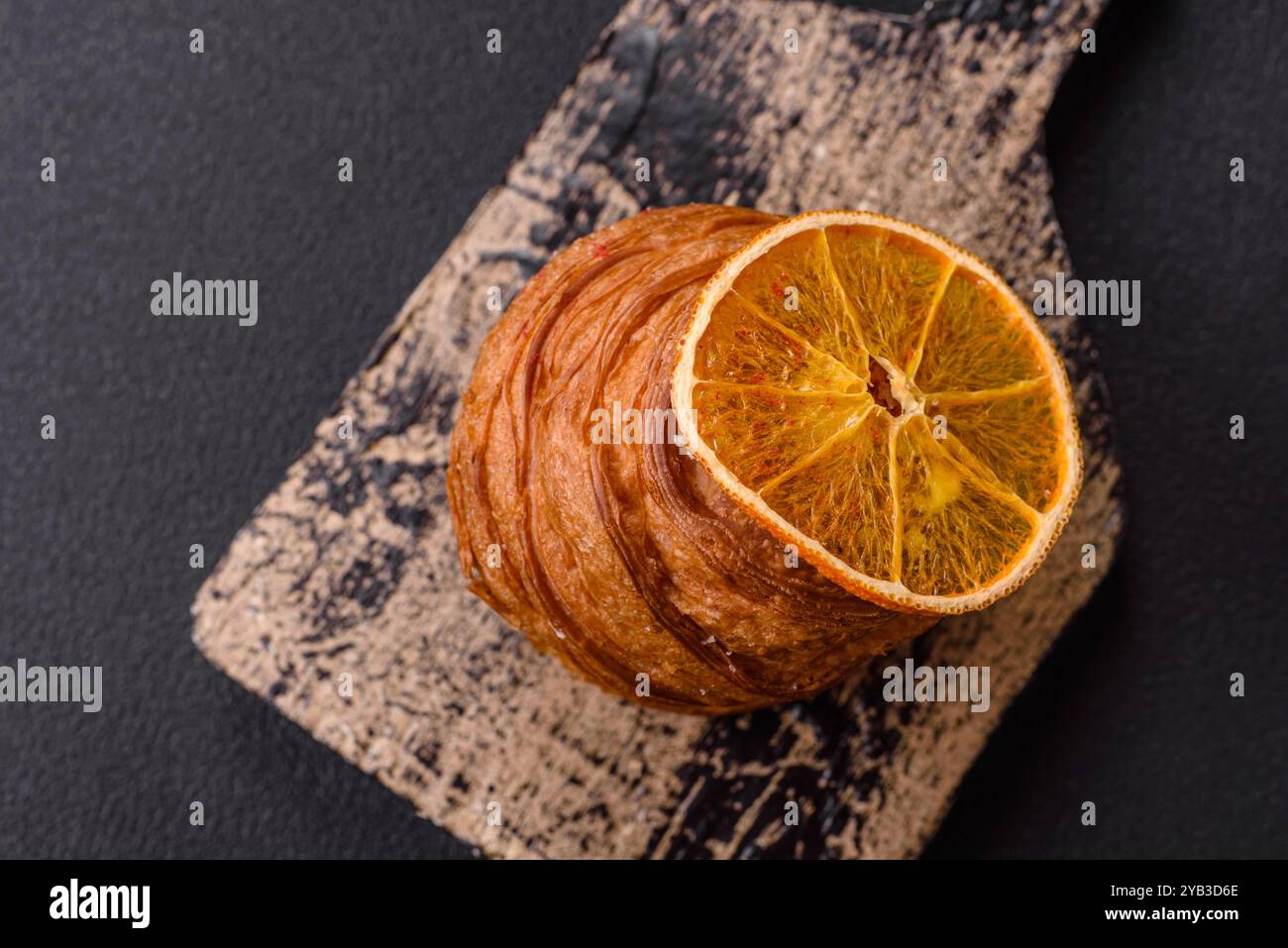 Sweet craffin made from puff pastry with Swiss meringue on a dark ...