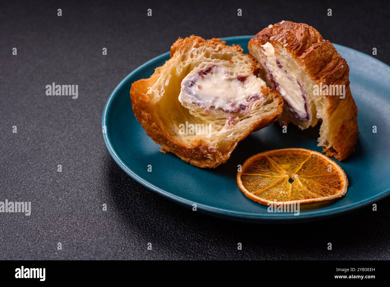 Sweet craffin made from puff pastry with Swiss meringue on a dark ...